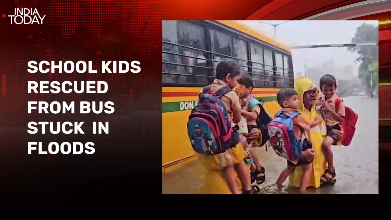 Video: Police rescue kids from school bus stuck in waterlogged road in ...