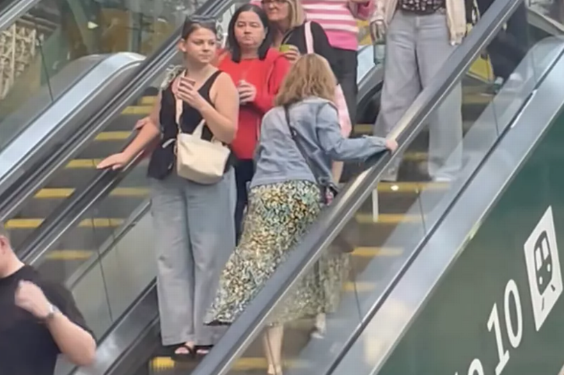 Woman struggles wrong way on the escalator in busy Scots station as ...