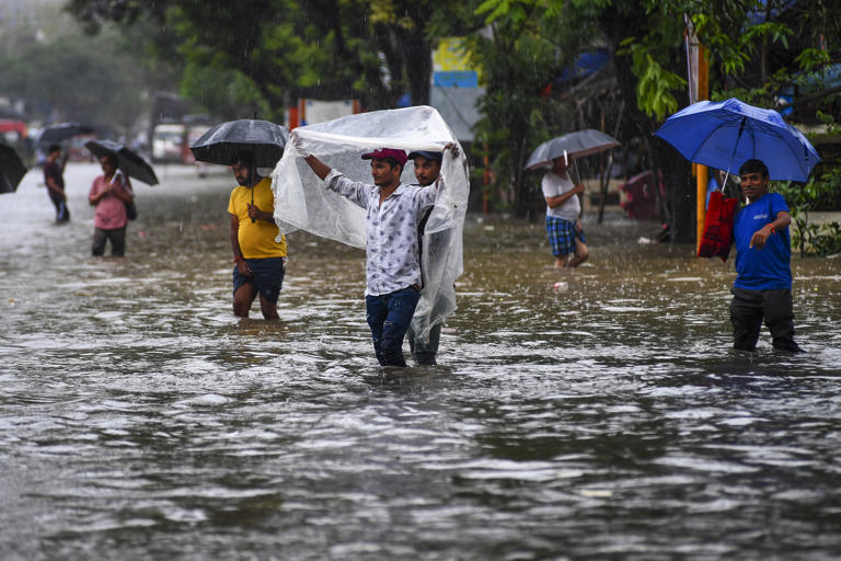 Mumbai reels under torrential rain; train services hit, normal life ...