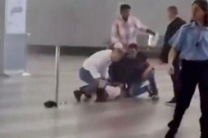 Man who set blaze at airport check-in desk smacked over head with fire ...