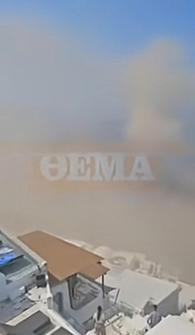 Massive landslide crashes into the sea in Santorini engulfing village with dust as tourists watch on