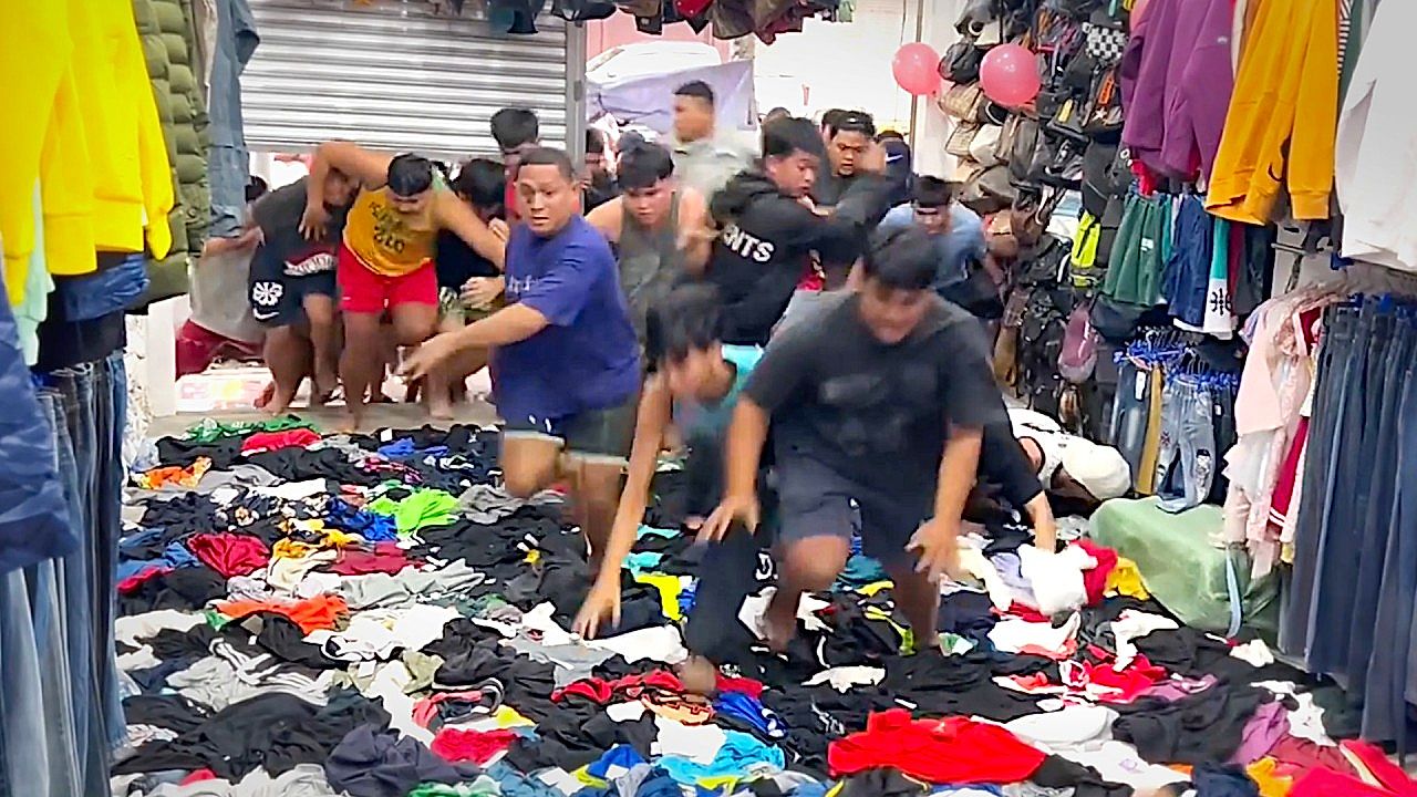 Bizarre moment bargain hunters storm clothes shop at opening in Philippines