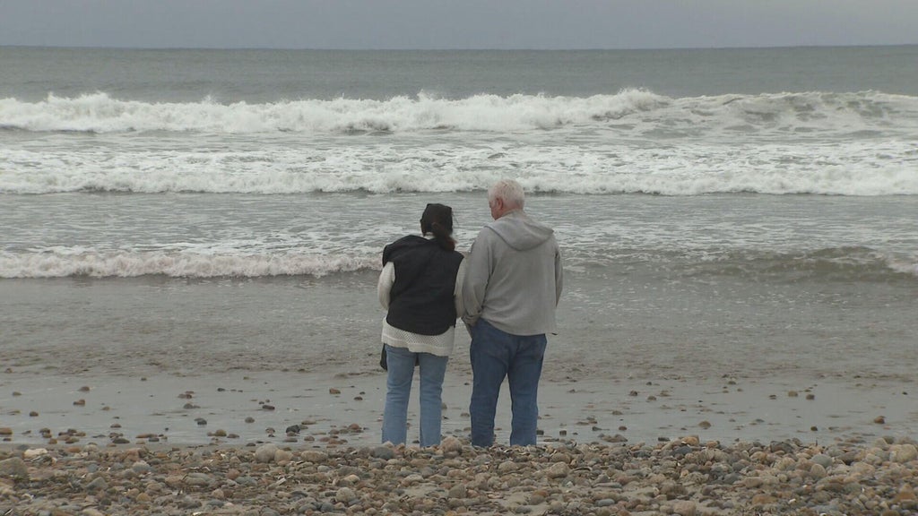 Beachgoers in Massachusetts take in huge waves from Hurricane Erin