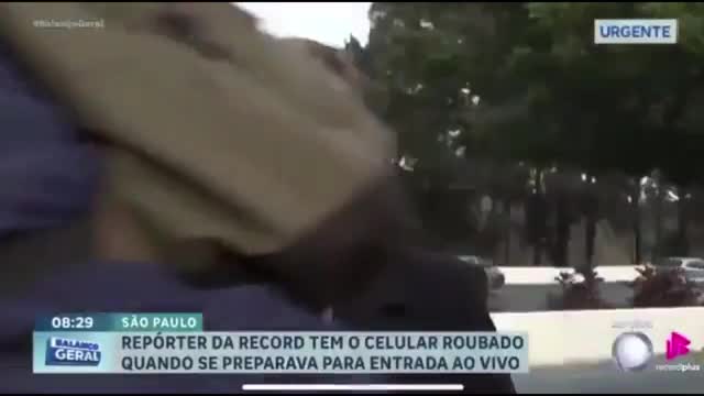 Moment news reporter has her phone snatched out of her hands live on TV