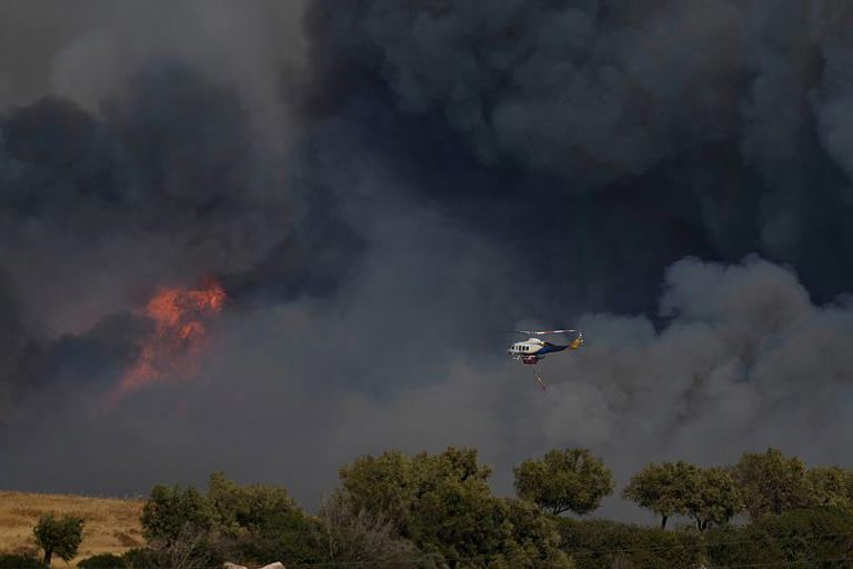Wildfires rage across southern Europe amid record temperatures