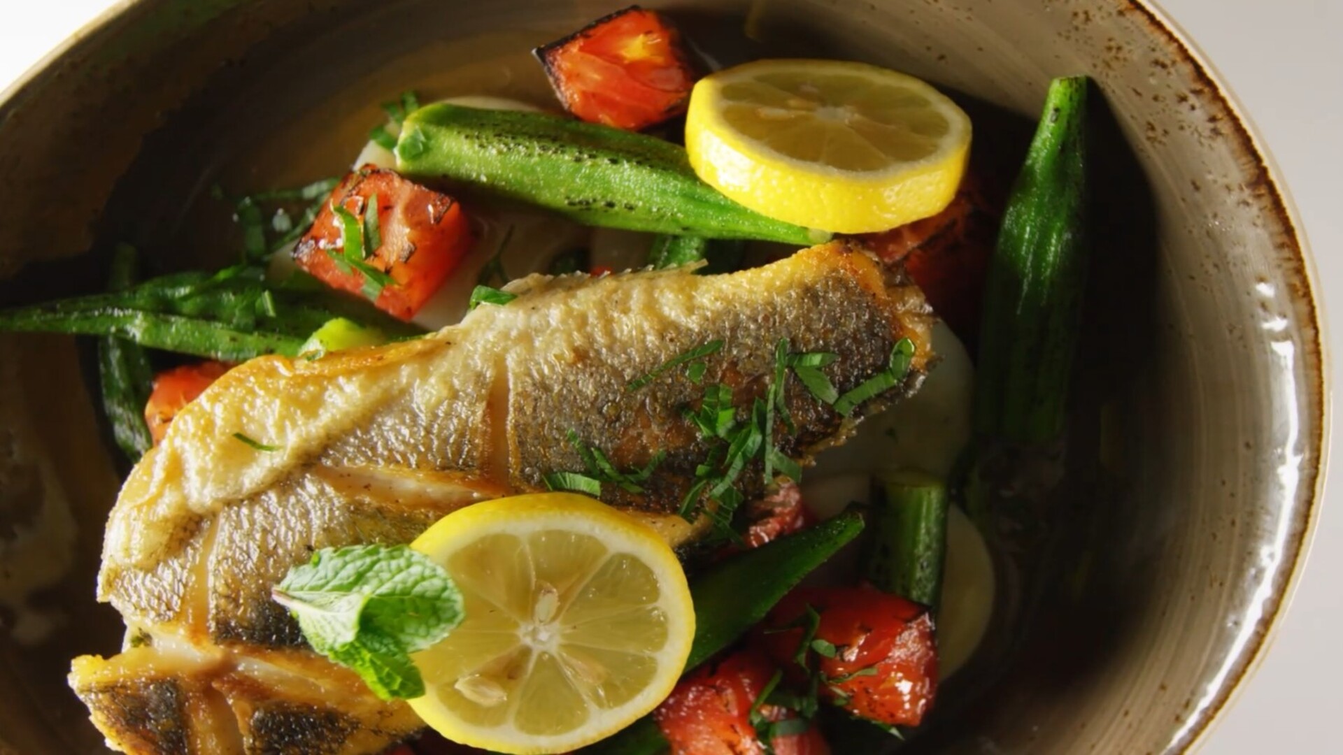 Baked sea bass with fresh herbs and layered flavors