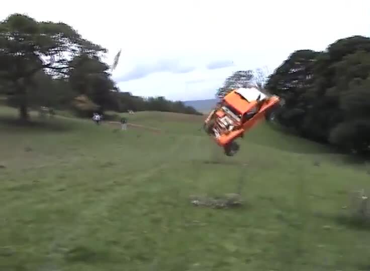 Orange Landrover Flips and Rolls