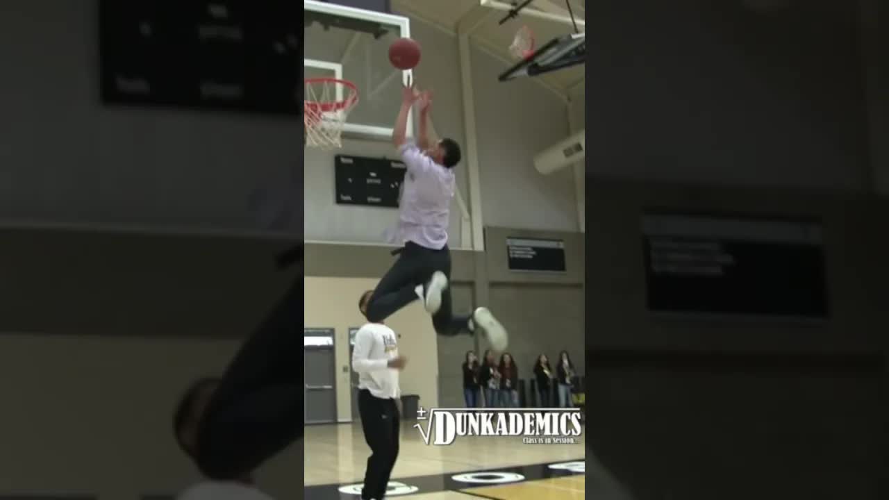 Teacher impresses students with backflip dunk