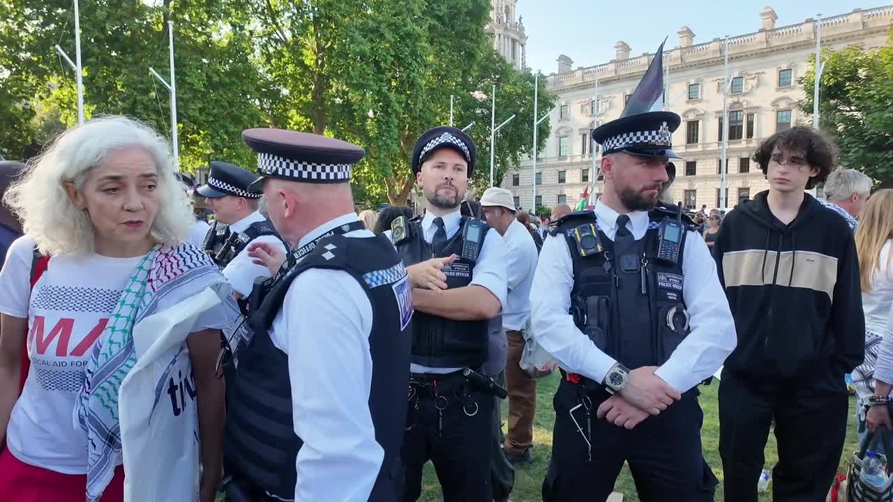 A long debate takes place between a Police Officer and members of the pro-Palestine Defend Our ...