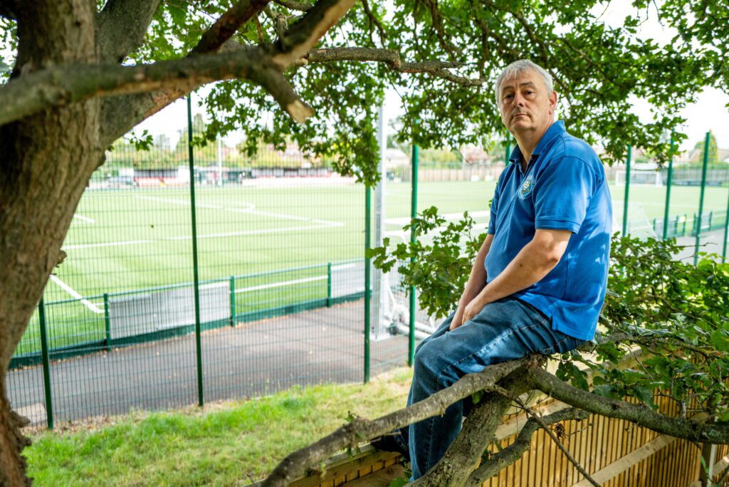 Banned football fan watches matches from tree overlooking stadium