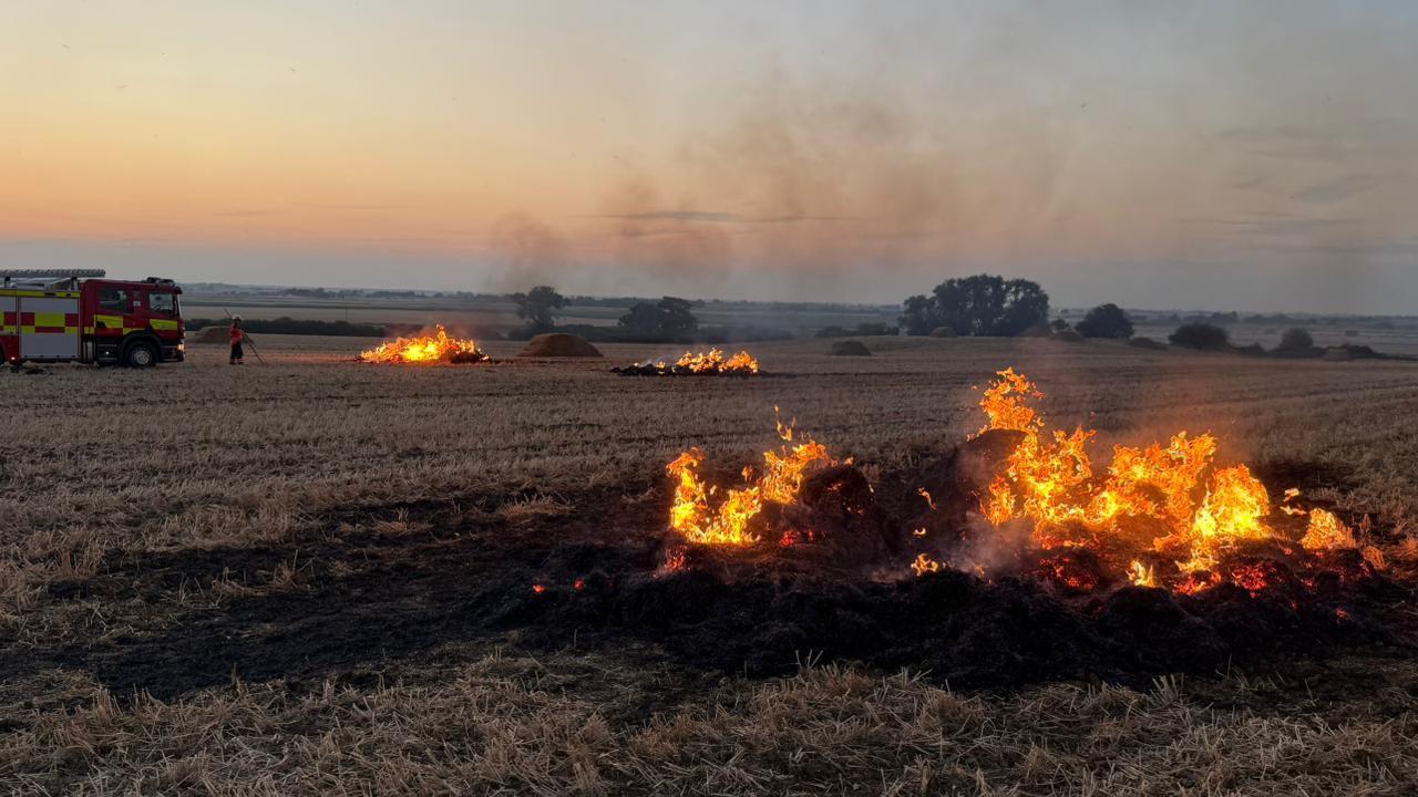 Crews fight deliberate bales fire in field