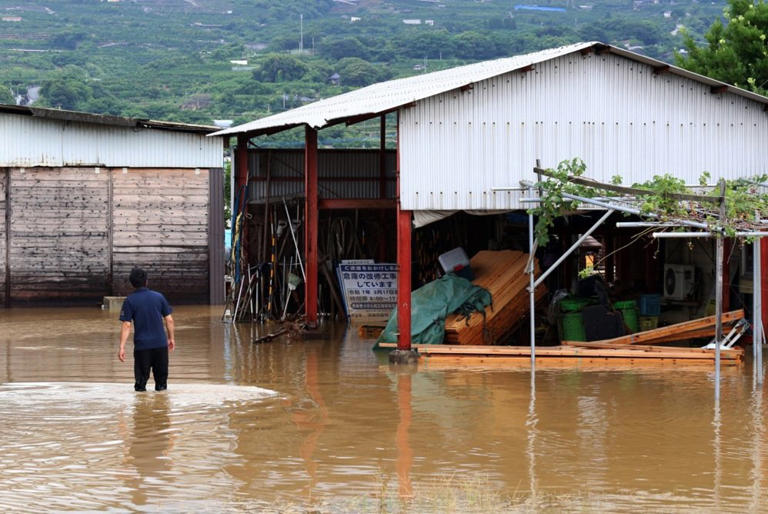 Two likely dead, many missing after record rain floods southern Japan