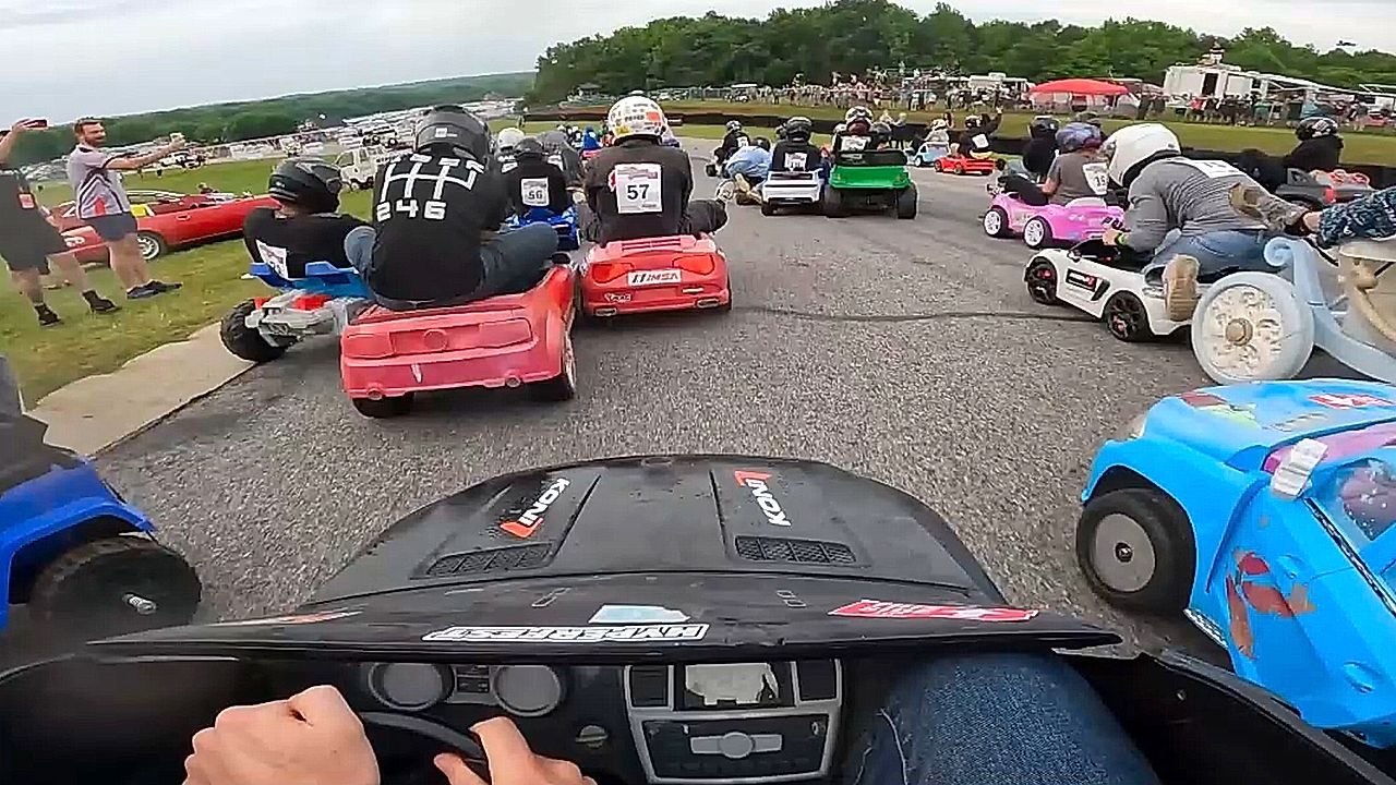 Adults race kids' toy cars downhill on Virginia International Raceway