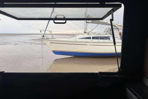 Sailing crew helped after vessel runs aground in shallow waters of ...