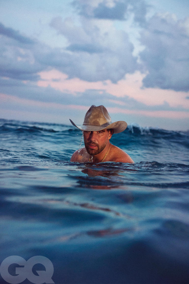 Travis Kelce models head-to-toe fur (and a huge Birkin bag) in the Florida heat for GQ