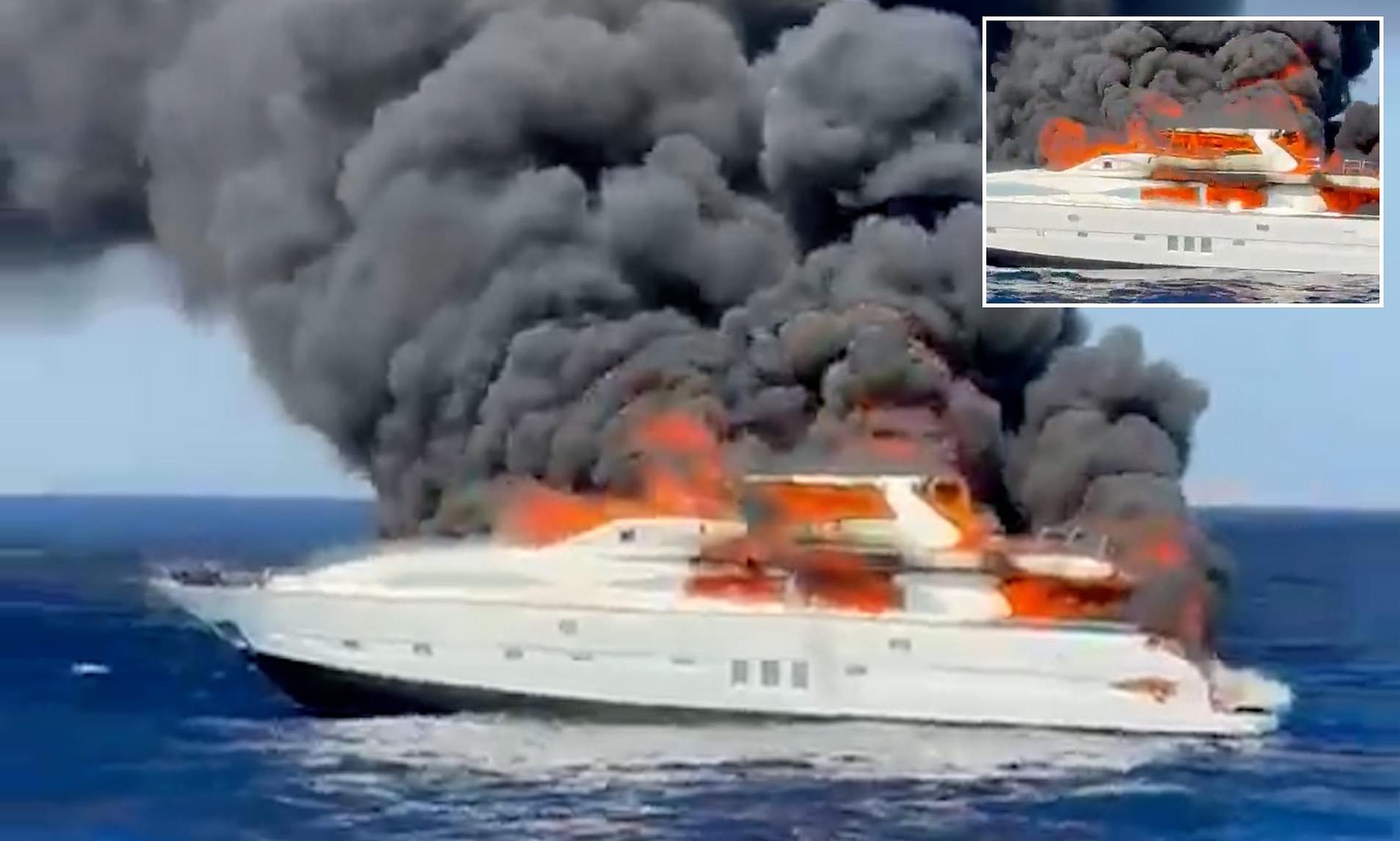 Moment yacht bursts into flames at sea before sinking
