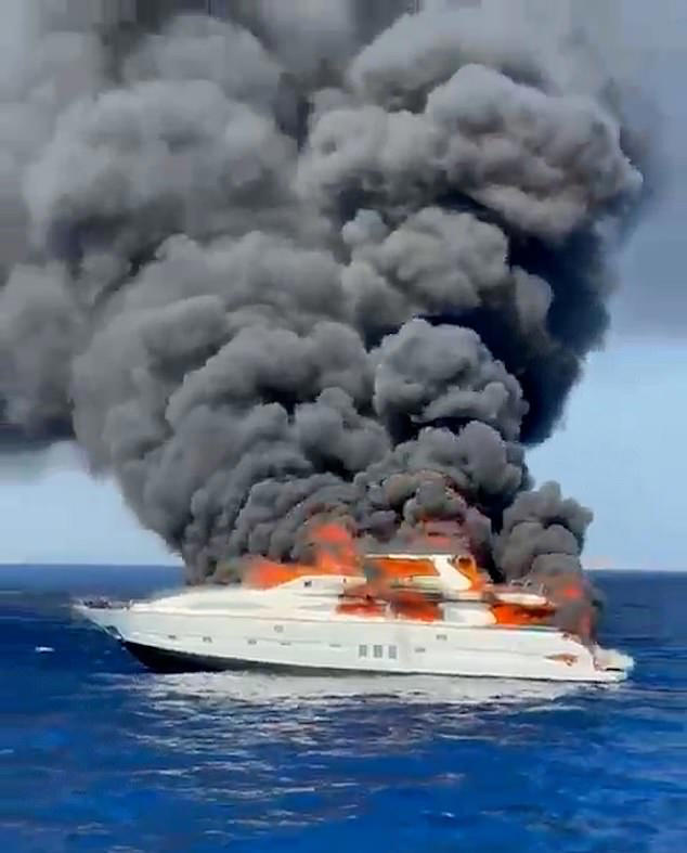 Moment yacht bursts into flames at sea before sinking