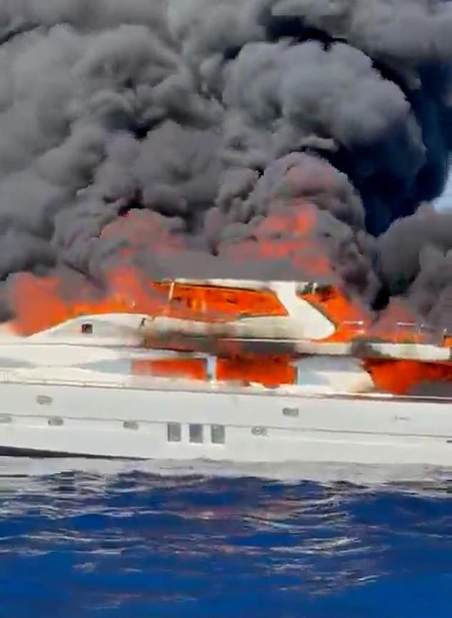 Moment yacht bursts into flames at sea before sinking
