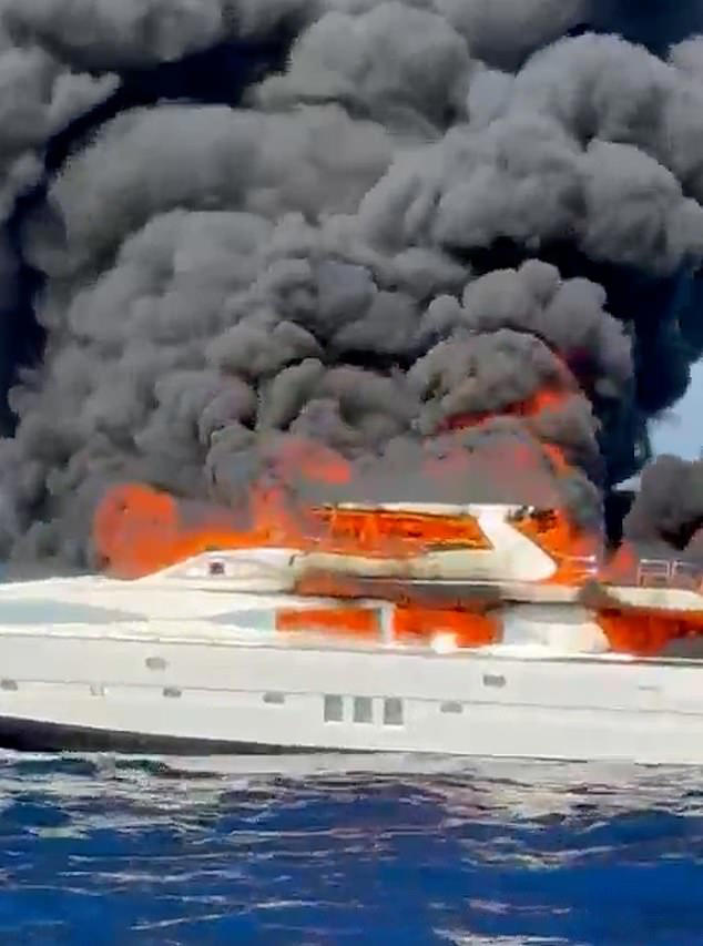 Moment yacht bursts into flames at sea before sinking