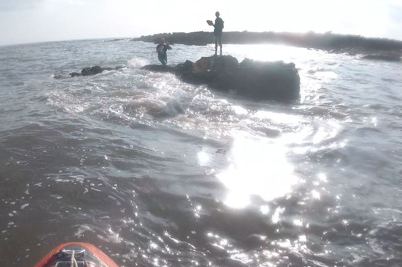 Teenagers rescued after getting stuck on rock as water rose around them