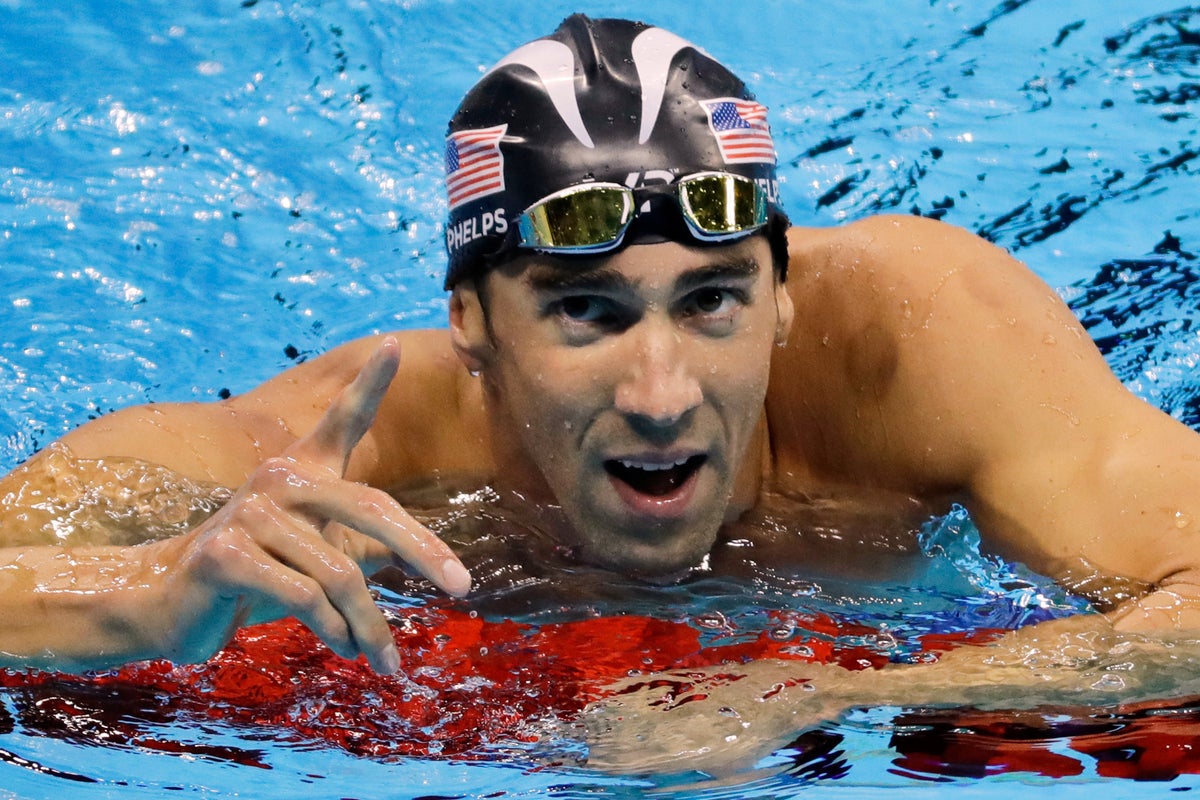 Michael Phelps returns to pool to race Baltimore Ravens players