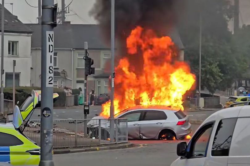 Dramatic footage shows crowds gather as car erupts into '30ft' flames