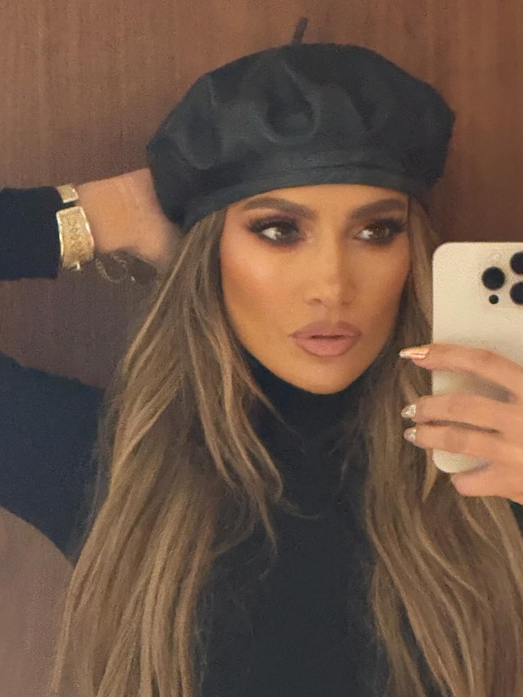 Jennifer Lopez shows off her legs in lace tights and a leather beret