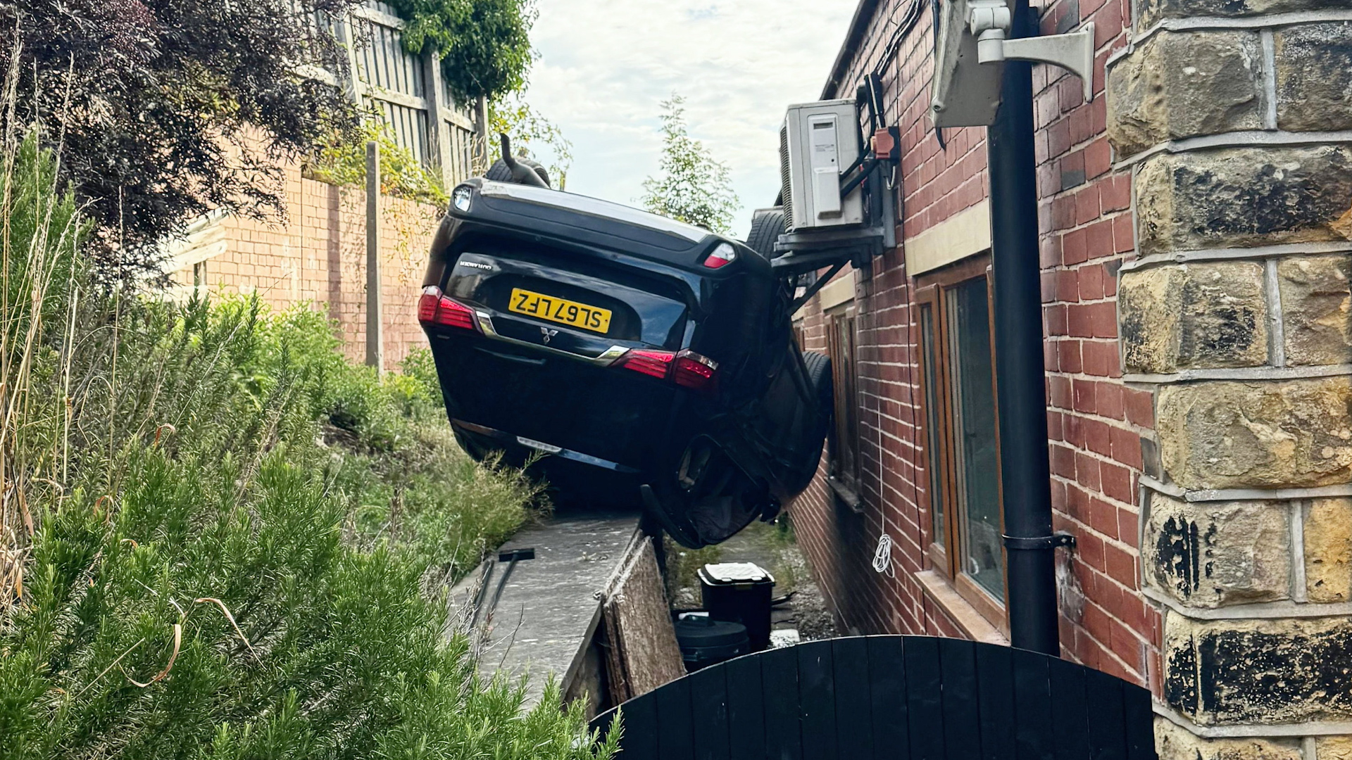 Staff shocked after car flips upside down and crashes through gym window
