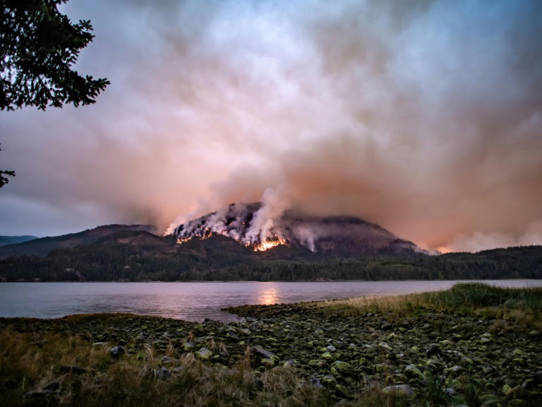 Massive fire burns on mountain near western Canada city