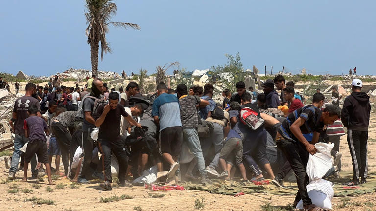 Photos: Gaza residents scramble for food as aid is airdropped