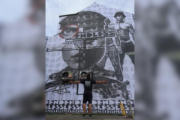 Provocative mural by street artist appears on city building