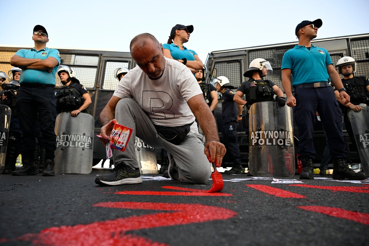 Riot police block protesters from approaching Israeli cruise ship in Greece
