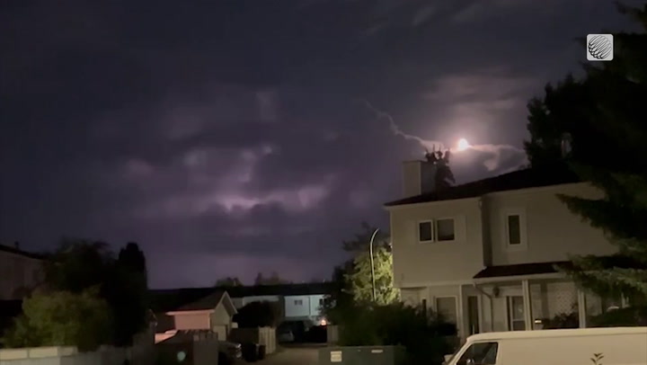 Thunderstorm filled with lightning passes over Red Deer, AB