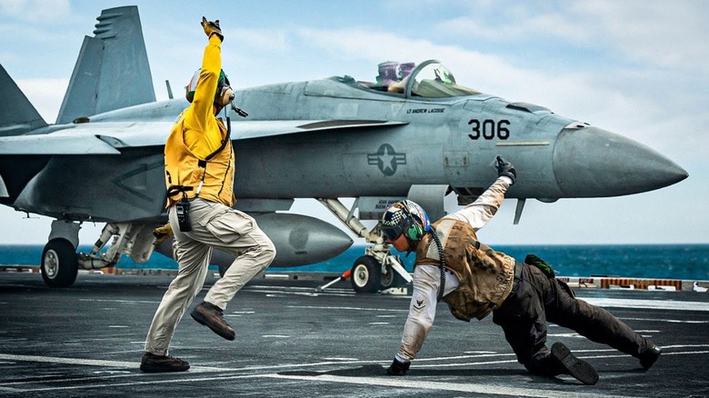 Why Do Aircraft Carrier Crews Touch The Flight Deck Before Launching A ...