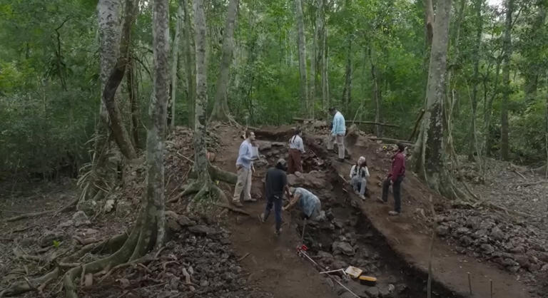 Archaeologists exploring in the shadow of an ancient Maya pyramid ...