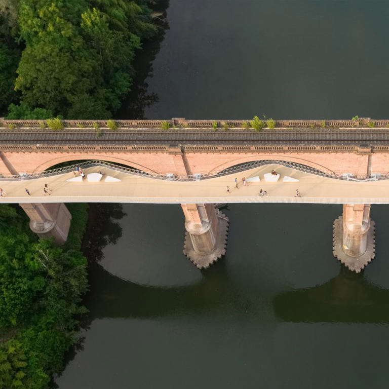 Ney and Partners curves footbridge between arches of French viaduct