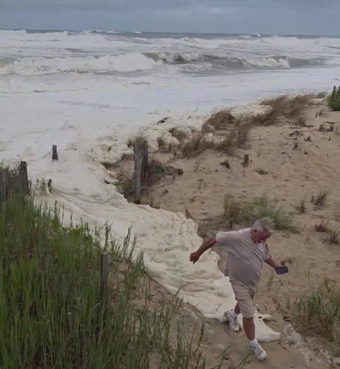 VIDEO: Surf chases man on OBX beach