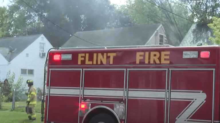 Crews battle fire at Flint home as smoke billows, owner says cat ...