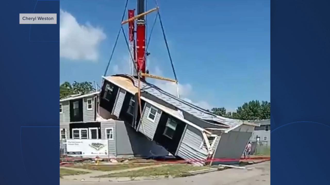 Modular home snaps while being dropped by crane