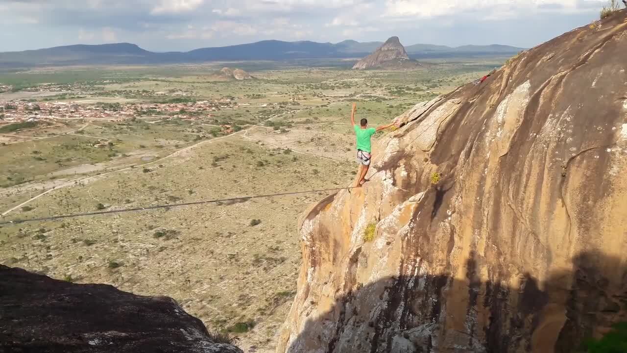 Guy Attempts To Cross Slack Line on Mountain Side