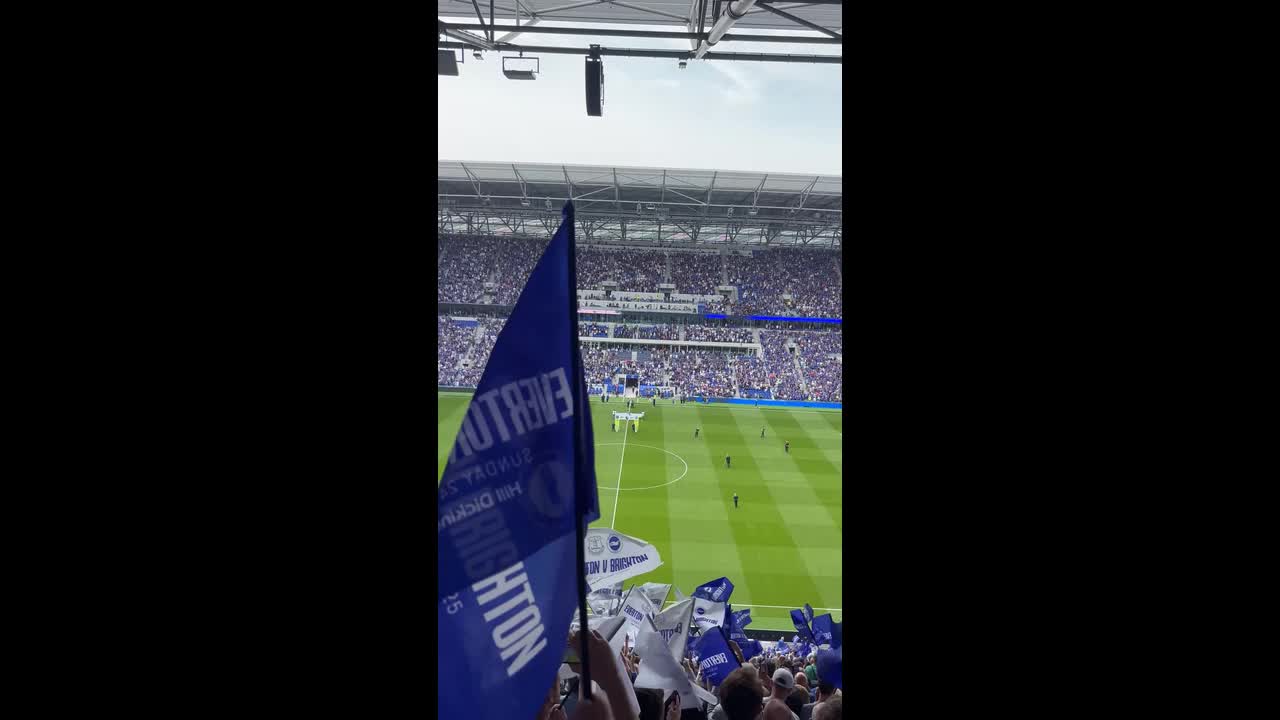 Everton fans welcome the team on to the pitch with flags ahead of club ...