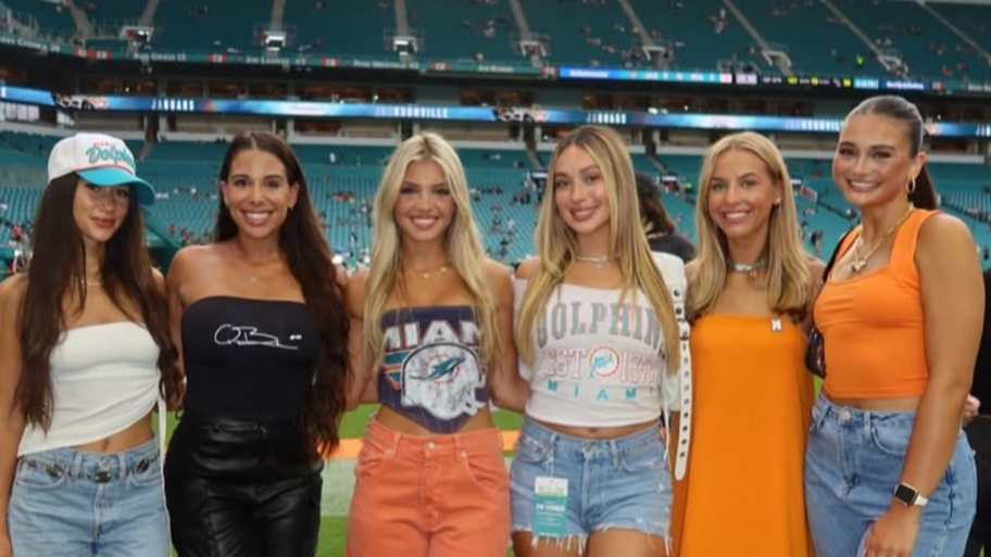 Zach Wilson’s wife Nicolette crushes in crop top with other Dolphins WAGs