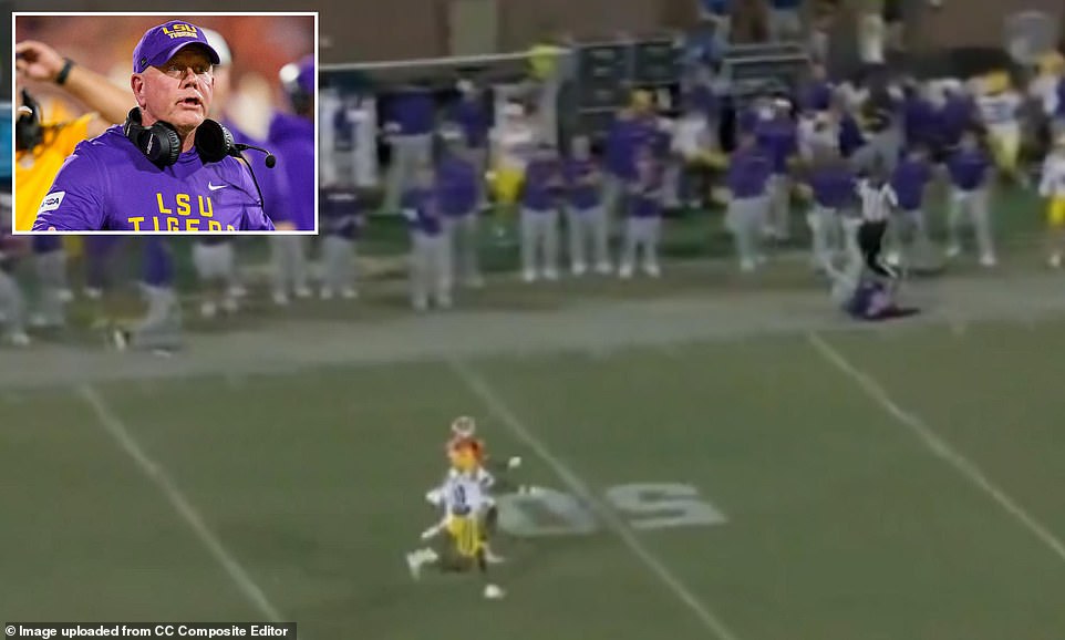 LSU coach Brian Kelly knocked to the ground after colliding with a referee