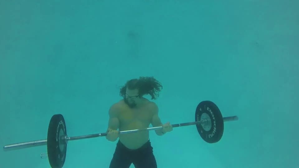 Muscle Man Lifts Weights Underwater