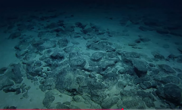 Ancient volcanic rock that glows green found on central Pacific ...