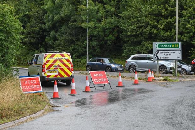 Three people injured in crash as road remains closed