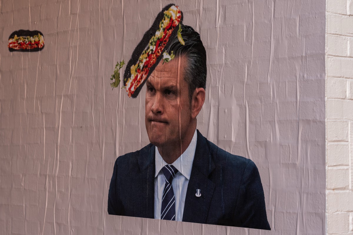 Posters showing Pete Hegseth and Stephen Miller being hit in head with ...