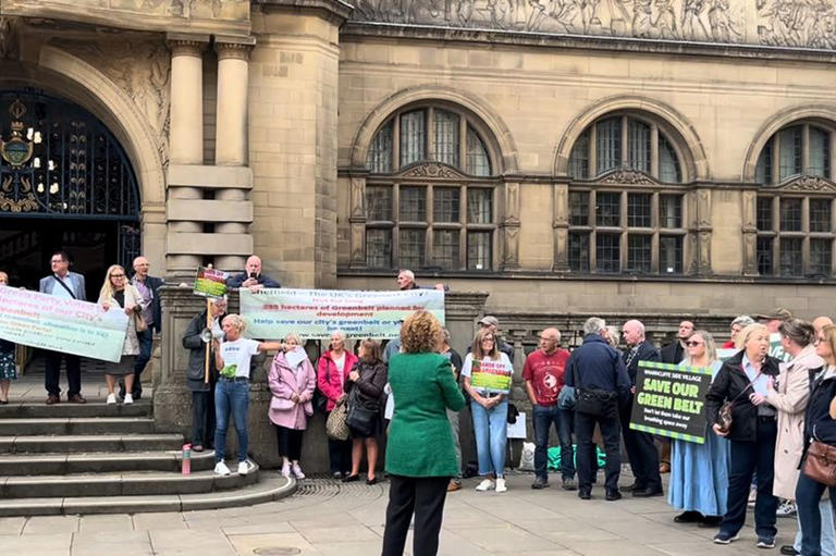 Councillors face two angry mobs of protestors outside town hall