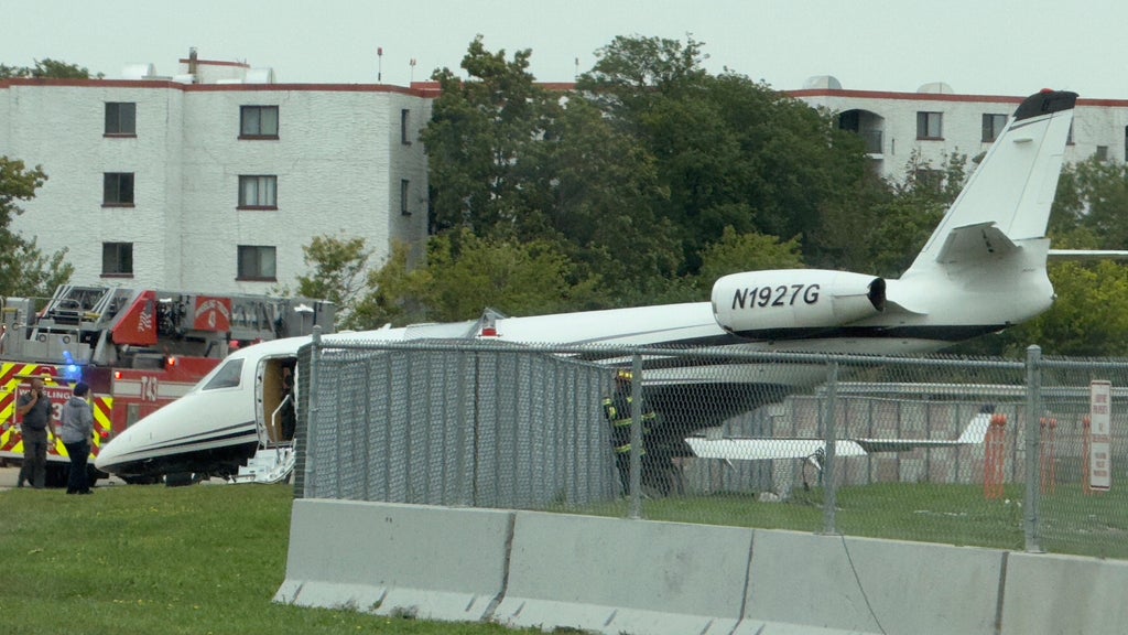 Small plane crashes through fence at Chicago Executive Airport in ...