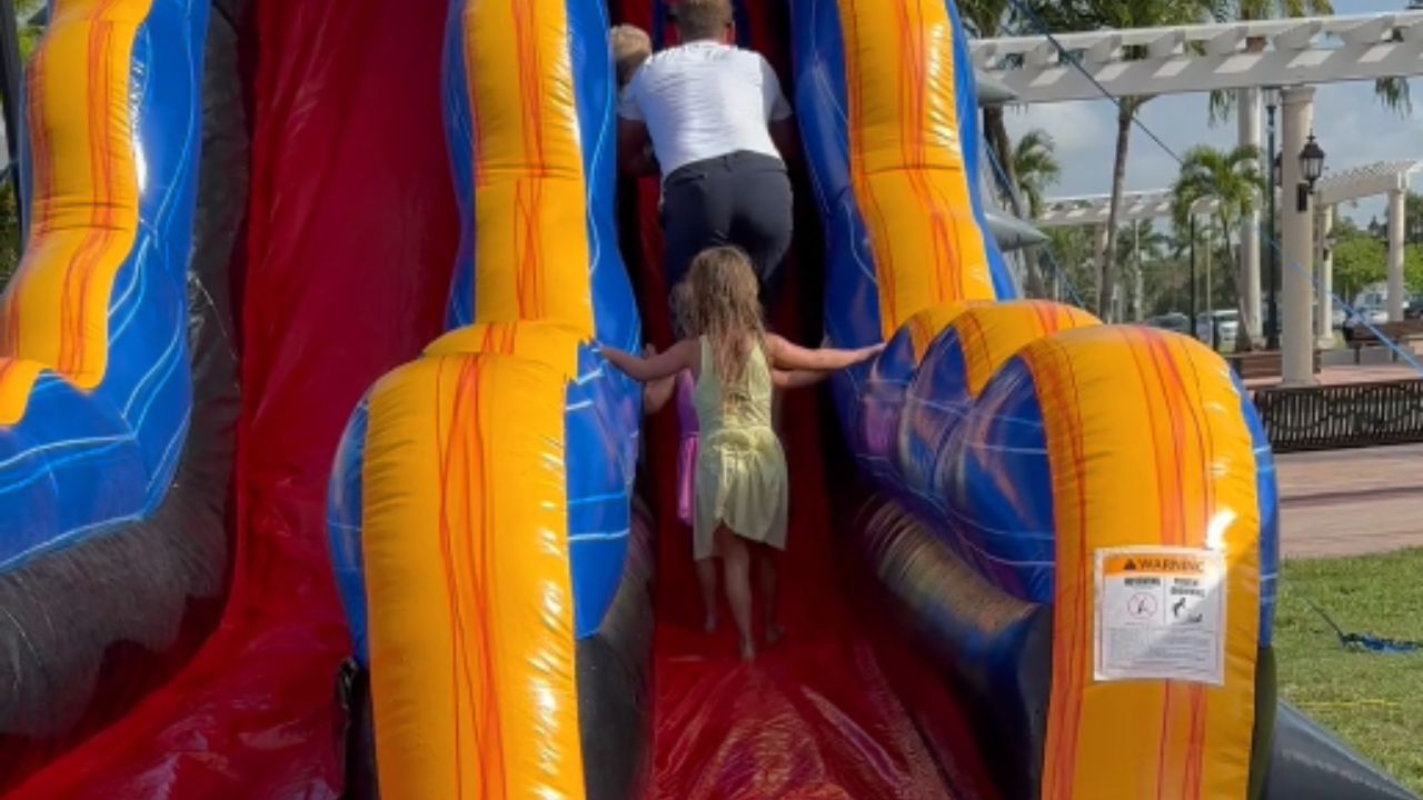 Dad slips while guiding his son on water slide and bumps into kids ...